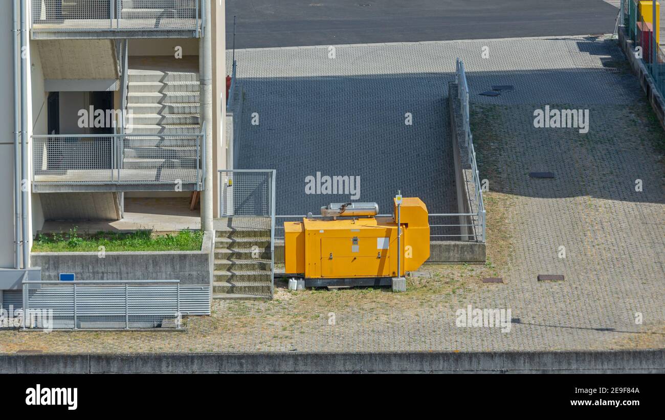Yellow Electric Power Generator Behind Office Building Stock Photo - Alamy