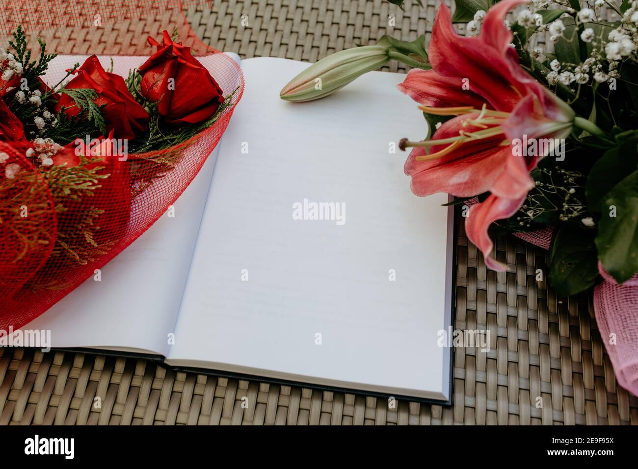 Open empty journal and flower Stock Photo - Alamy