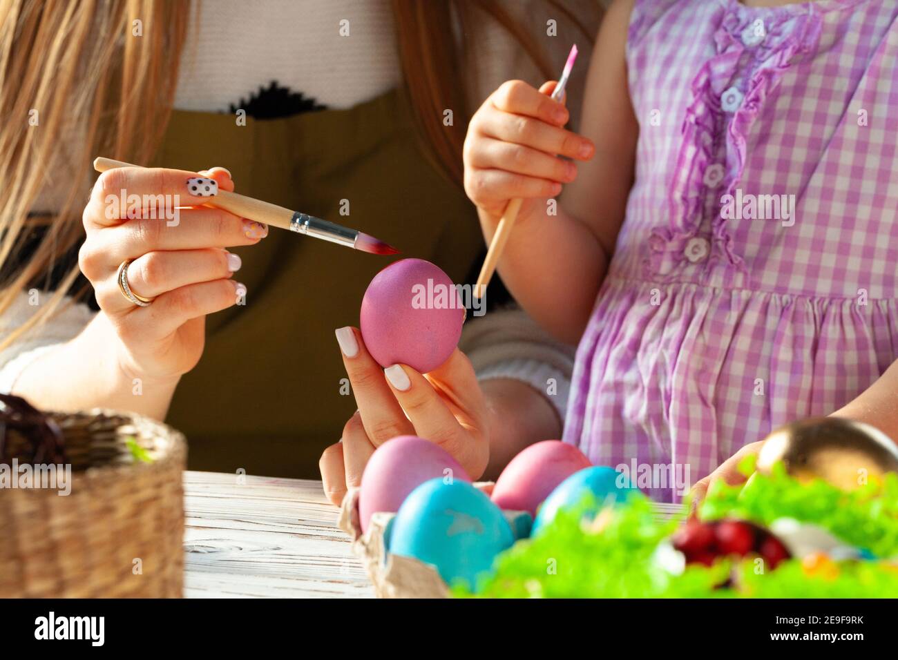 Mother and daughter coloring eggs for Easter Stock Photo - Alamy