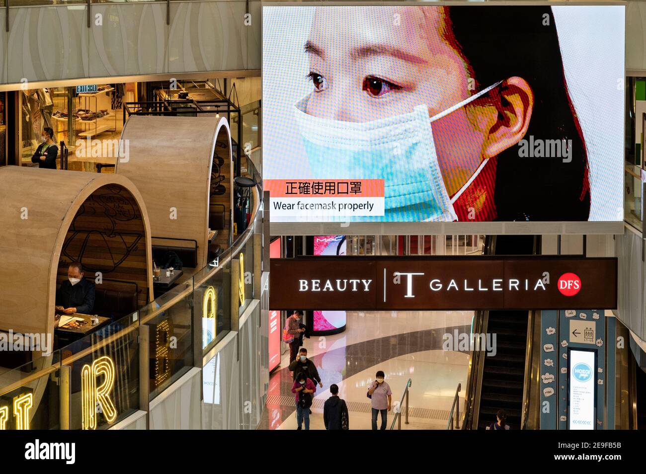 A large-size screen at a shopping mall displaying a video to remind the ...