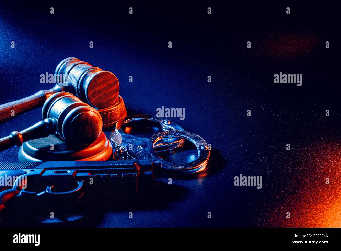 Gun and judge's gavel on the table. Crime, robbery, attack concept ...