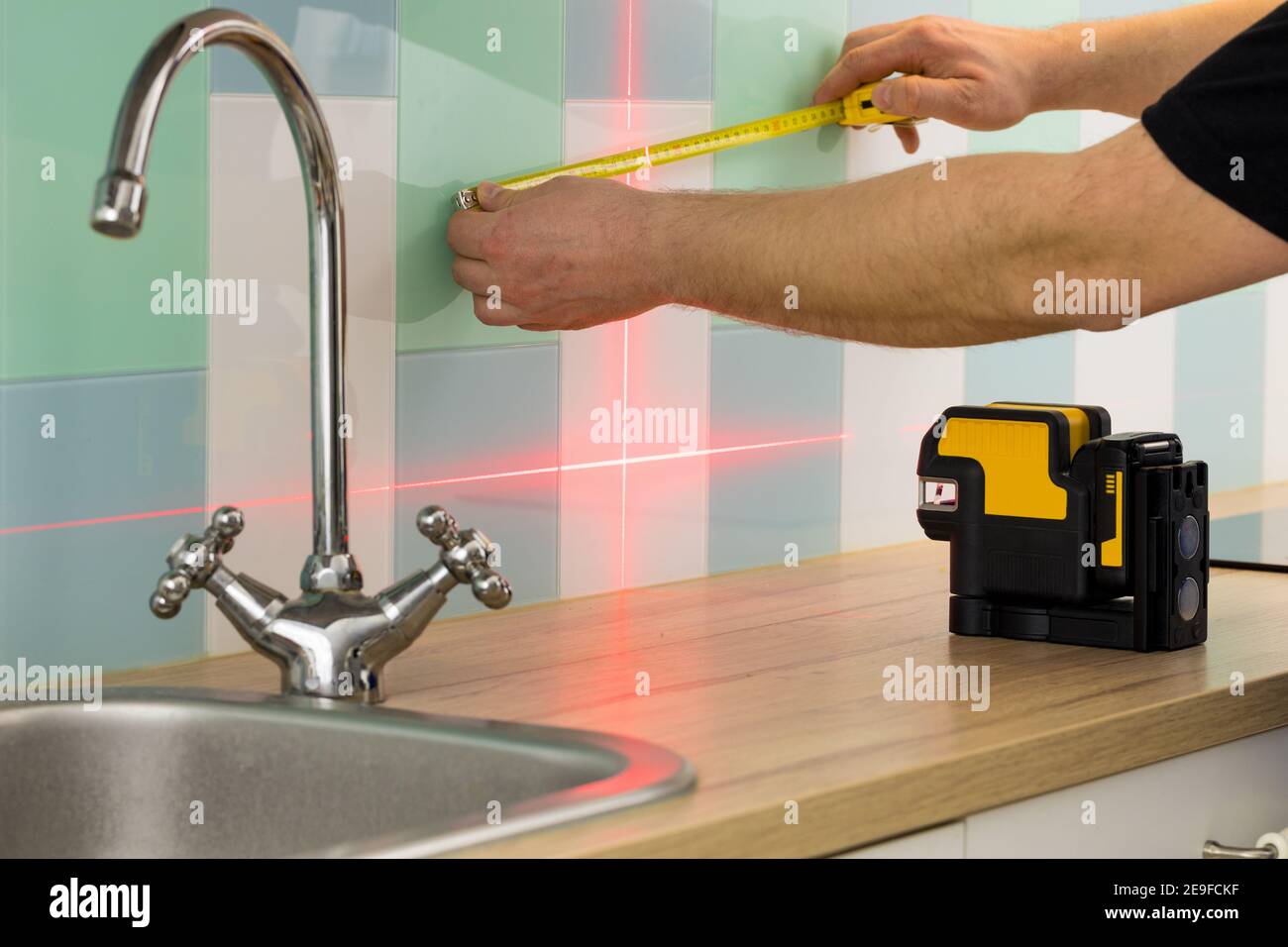 A professional checks the angles while taking measurements of the ...