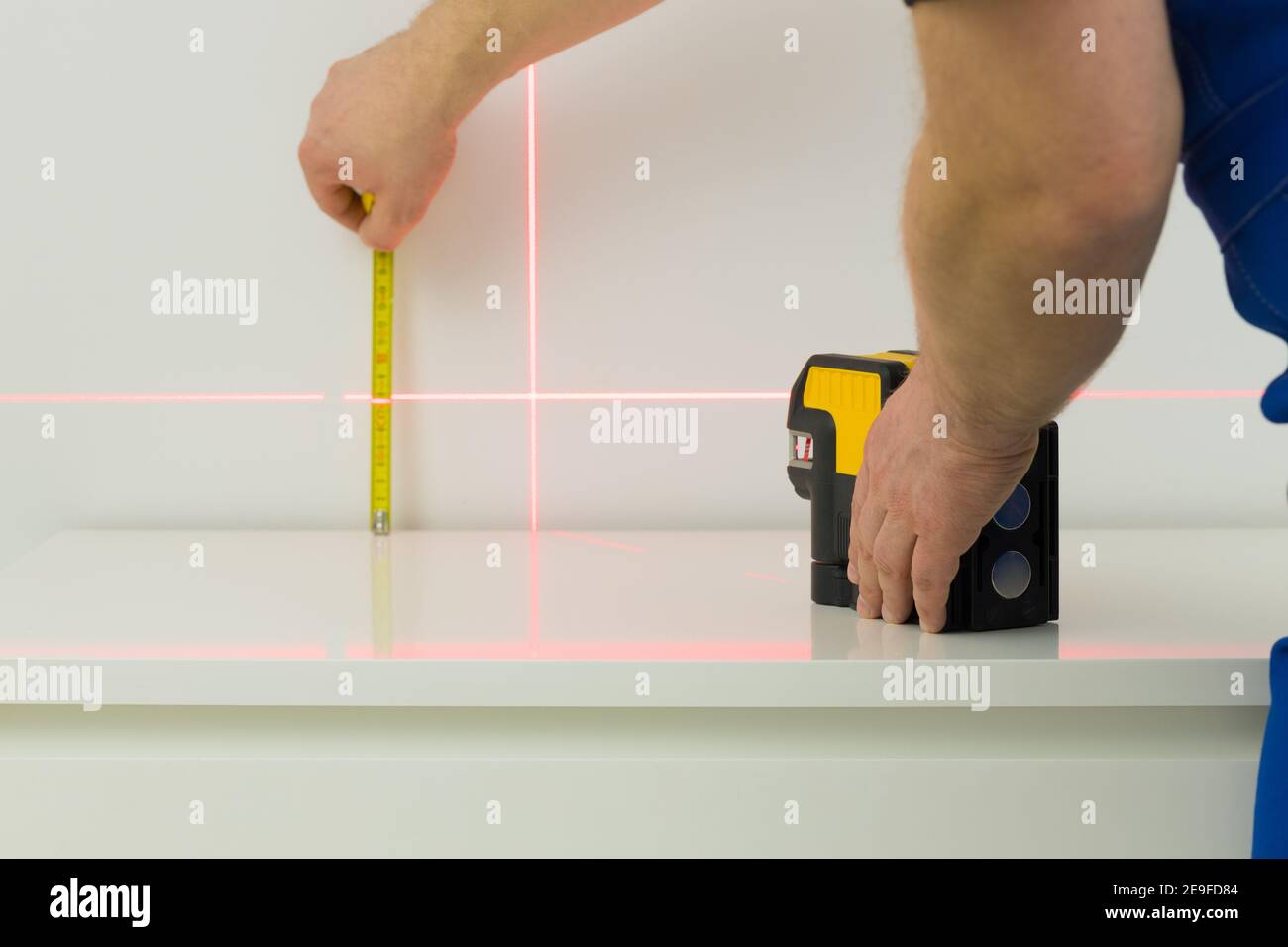 a specialist makes measurements using an electronic laser measuring the ...