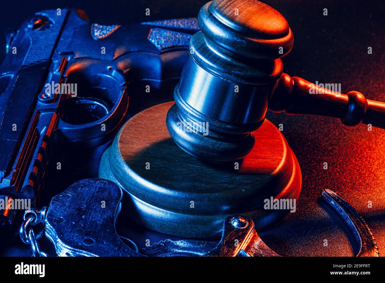 Gun and judge's gavel on the table. Crime, robbery, attack concept ...