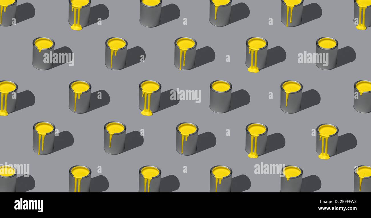Yellow paint in tin cans aligned in a pattern, full-frame, isolated on ...