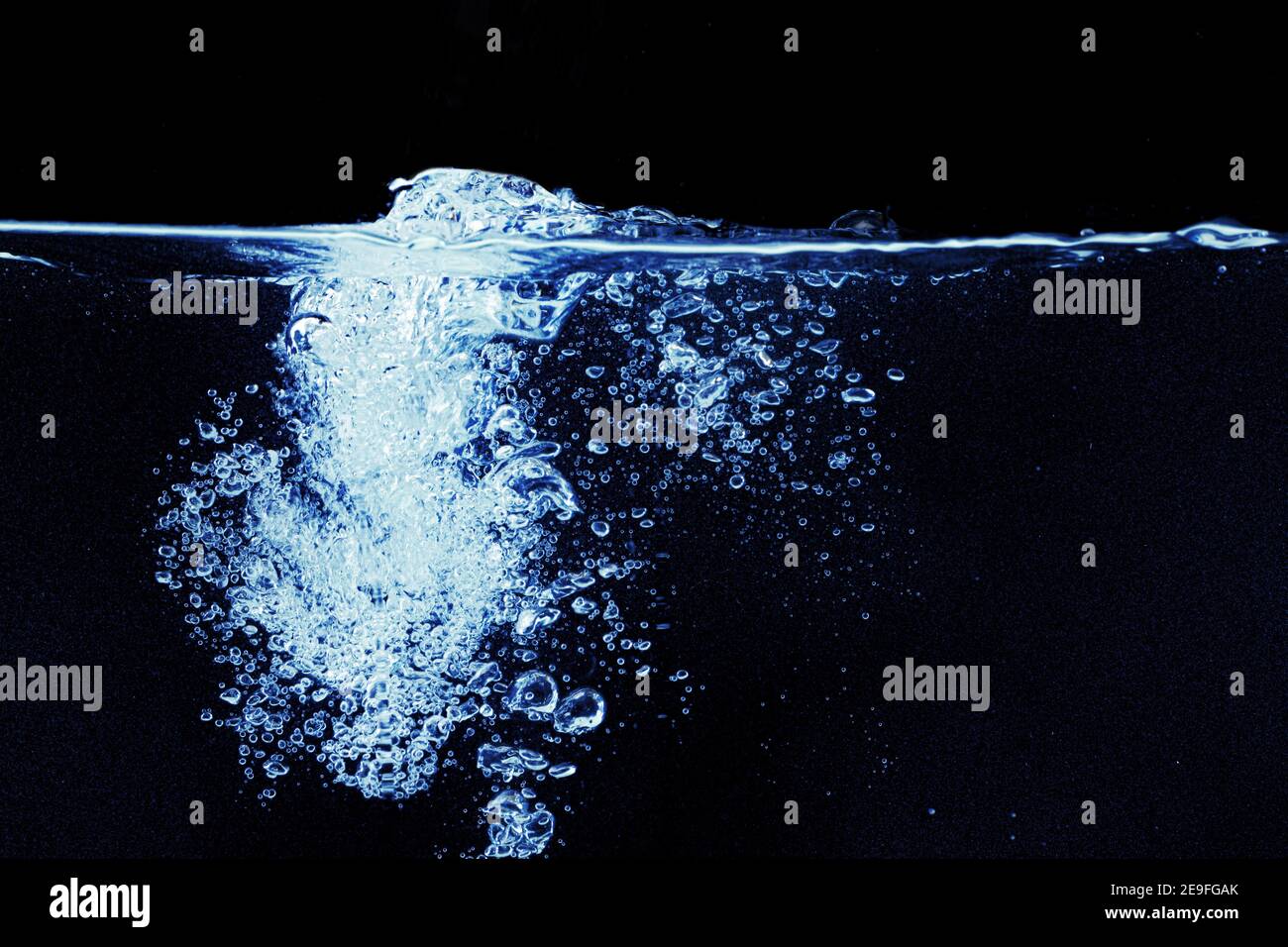 Water splash in aquarium isolated on black background Stock Photo - Alamy