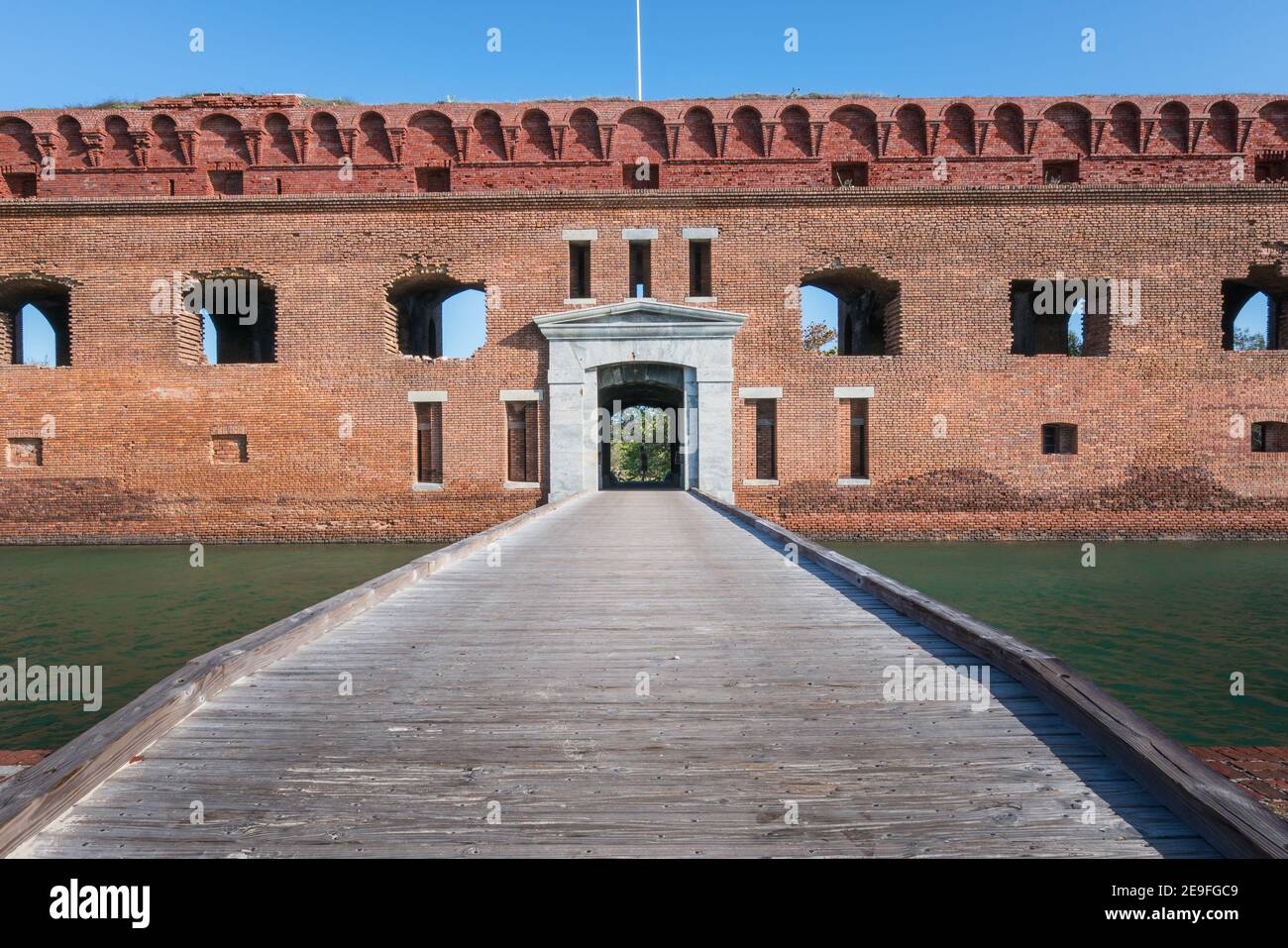 Gate of an old military fort with a wooden walk in the foreground. Big ...