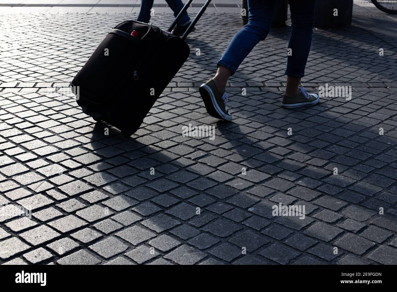 Detail of people rushing over the pavement at a train station during ...