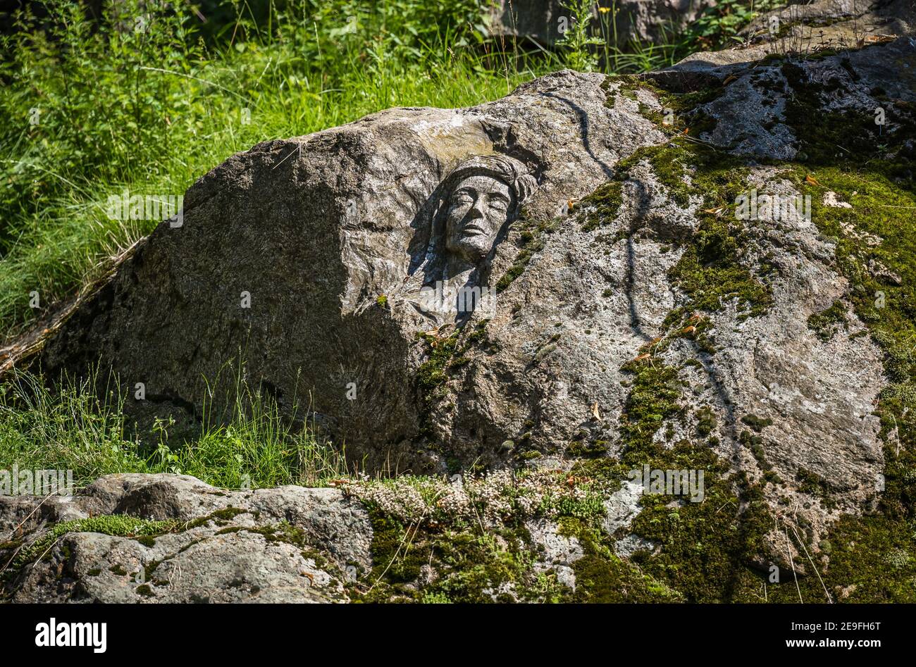Low angle shot of a wonderful female face engraved on a stone Stock ...