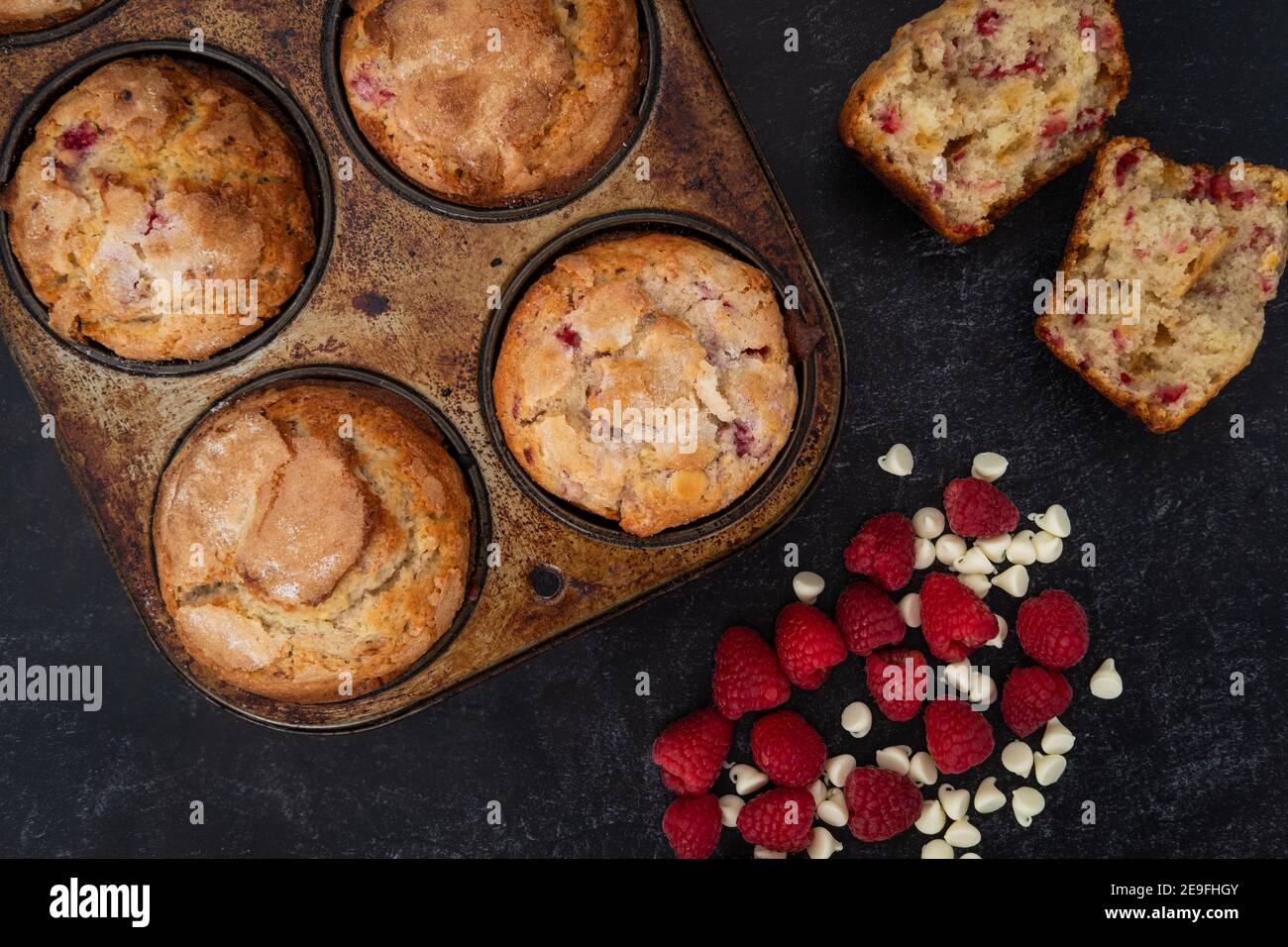 Freshly baked Raspberry White Chocolate Muffins Cooling on the counter ...