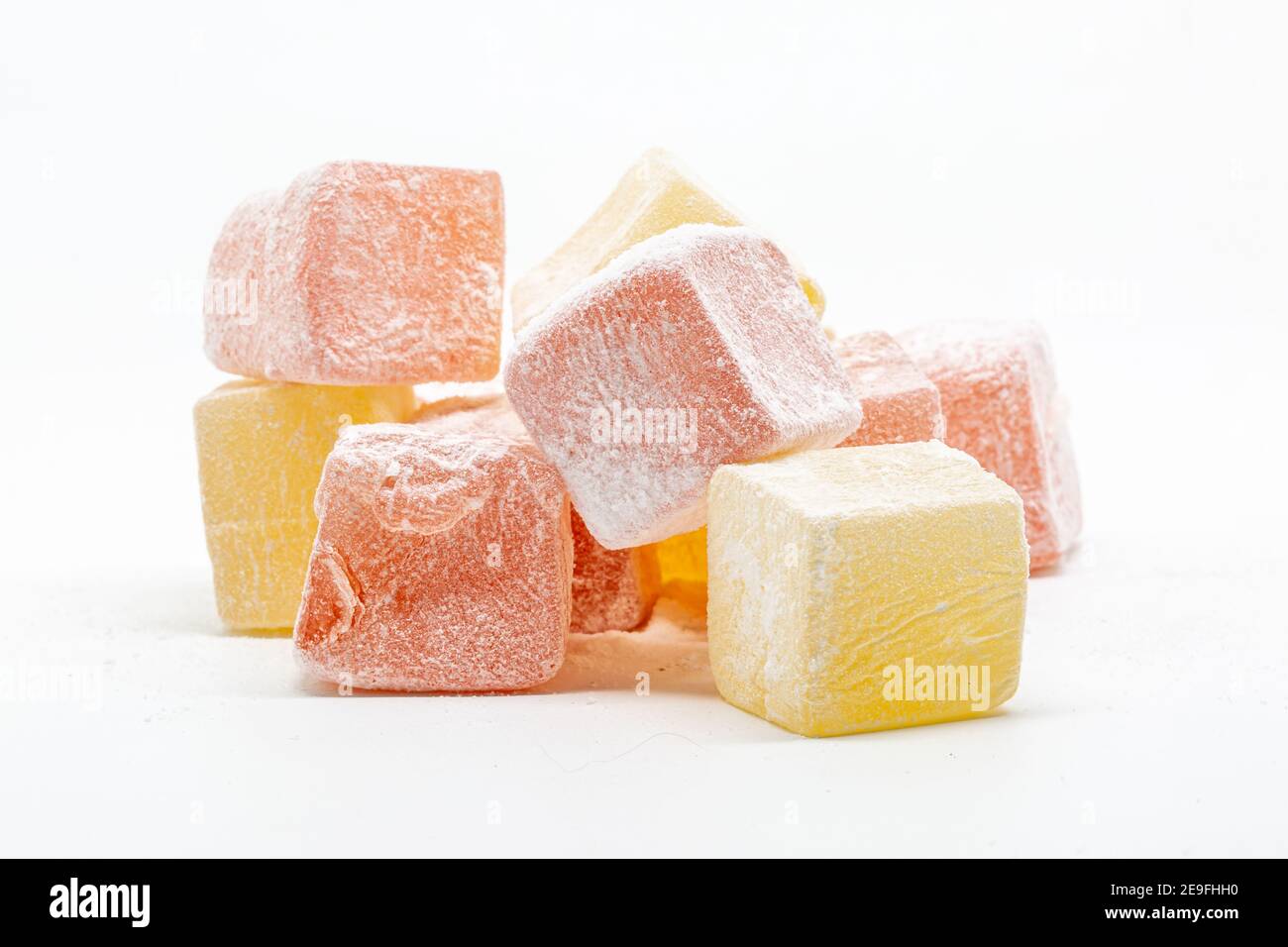 Sugary pink and yellow Turkish Delight, isolated against a white ...
