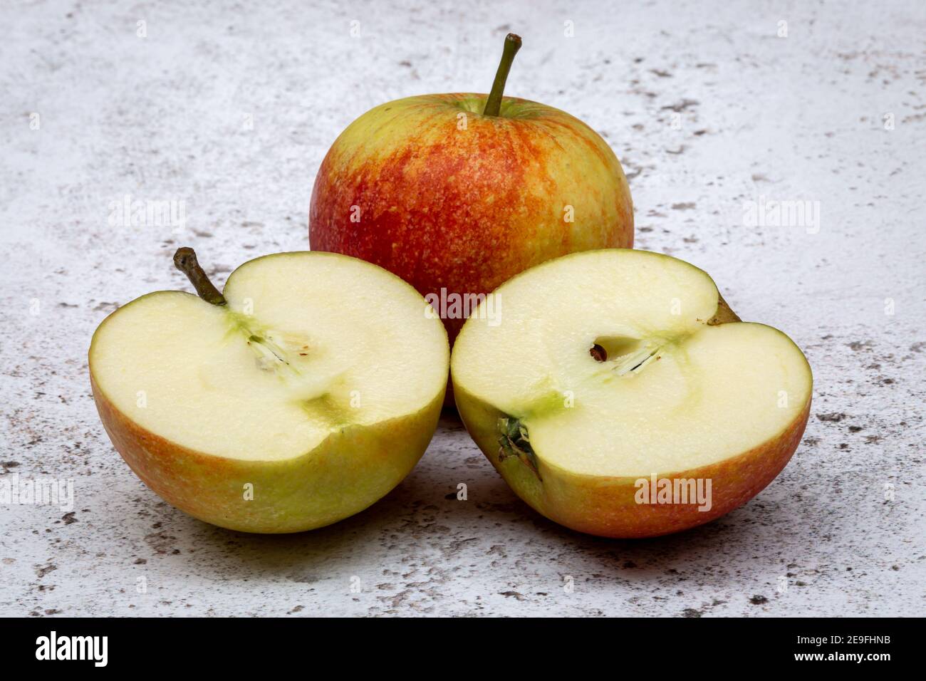 A close up of a whole and a cut apple Stock Photo - Alamy