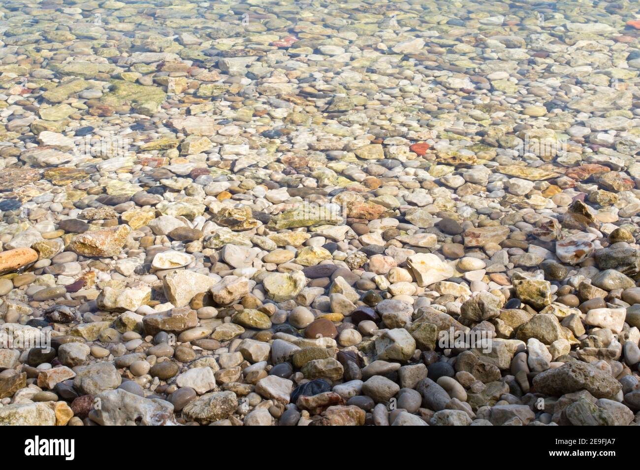 Colorful sea stones under water, sea pebbles, transparent clear water ...