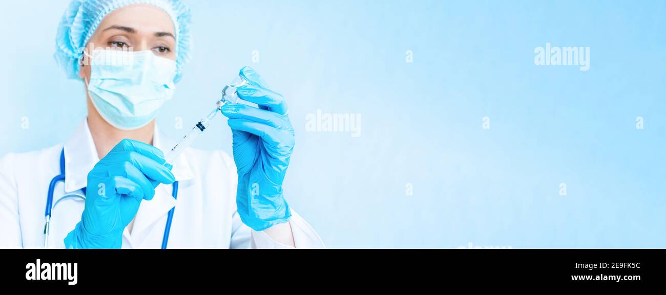 Attractive female doctor isolated on blue background long banner for ...
