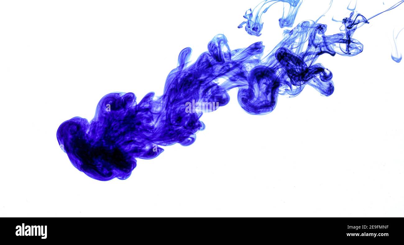 Blue ink injected into water from syringe, colour mixing with water ...