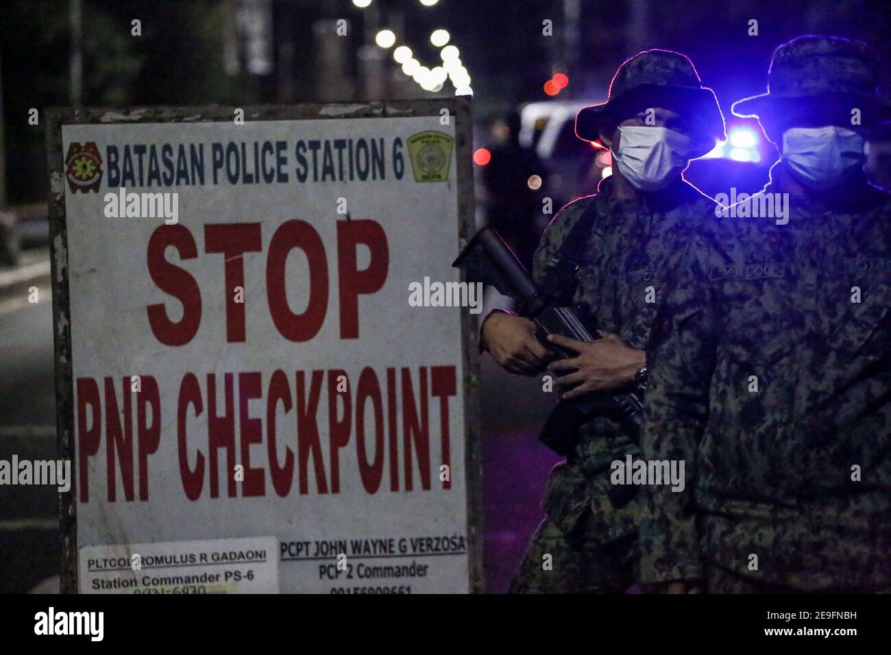 Filipino soldiers stand guard at a checkpoint after being deployed as ...