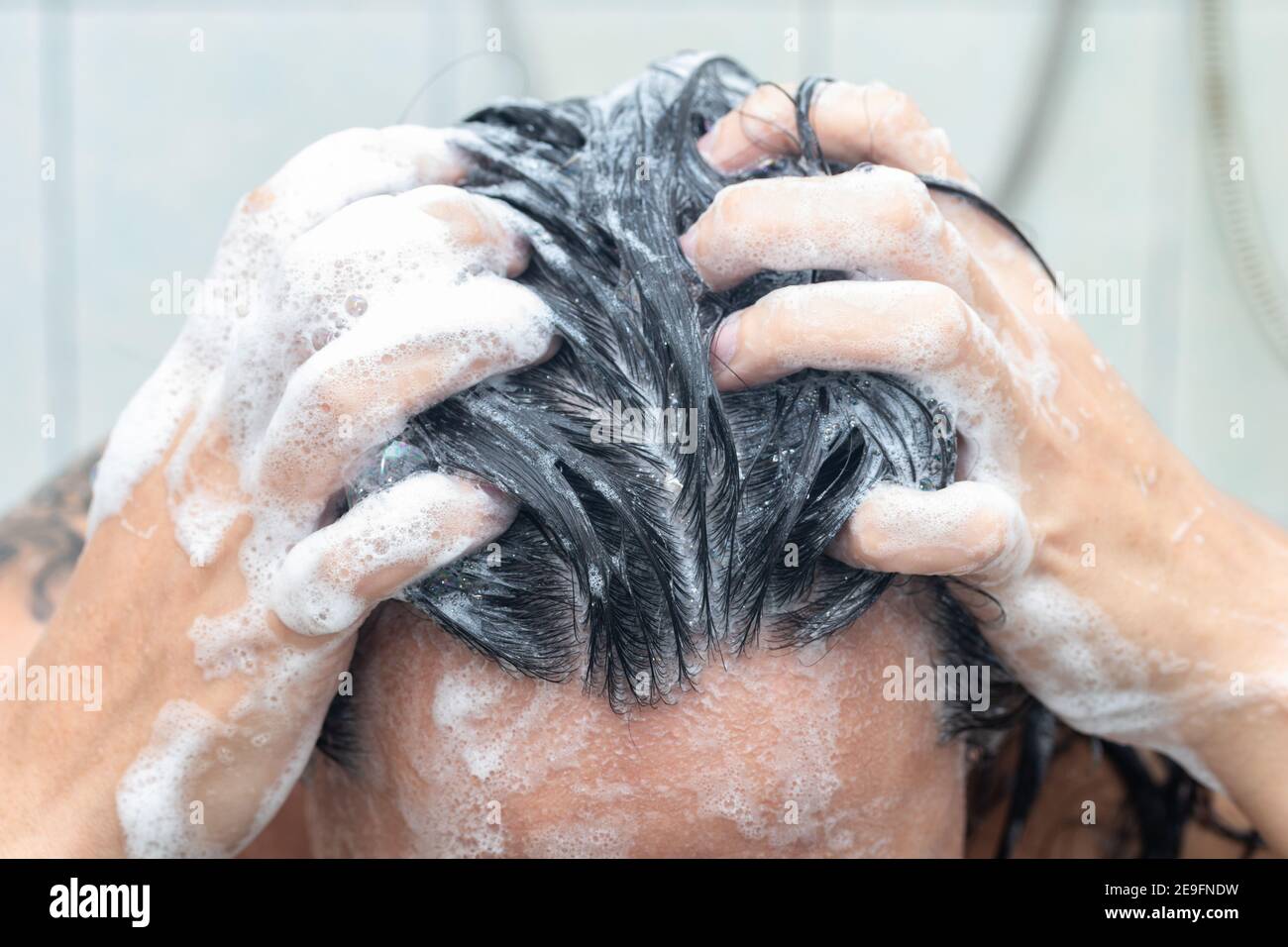 Asian man are washing their hair in a bathroom with a full head bubble ...