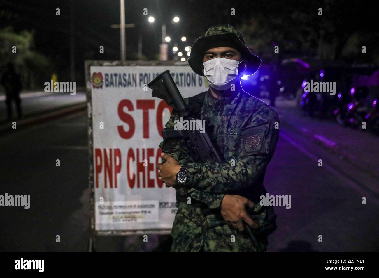 Filipino soldiers stand guard at a checkpoint after being deployed as ...