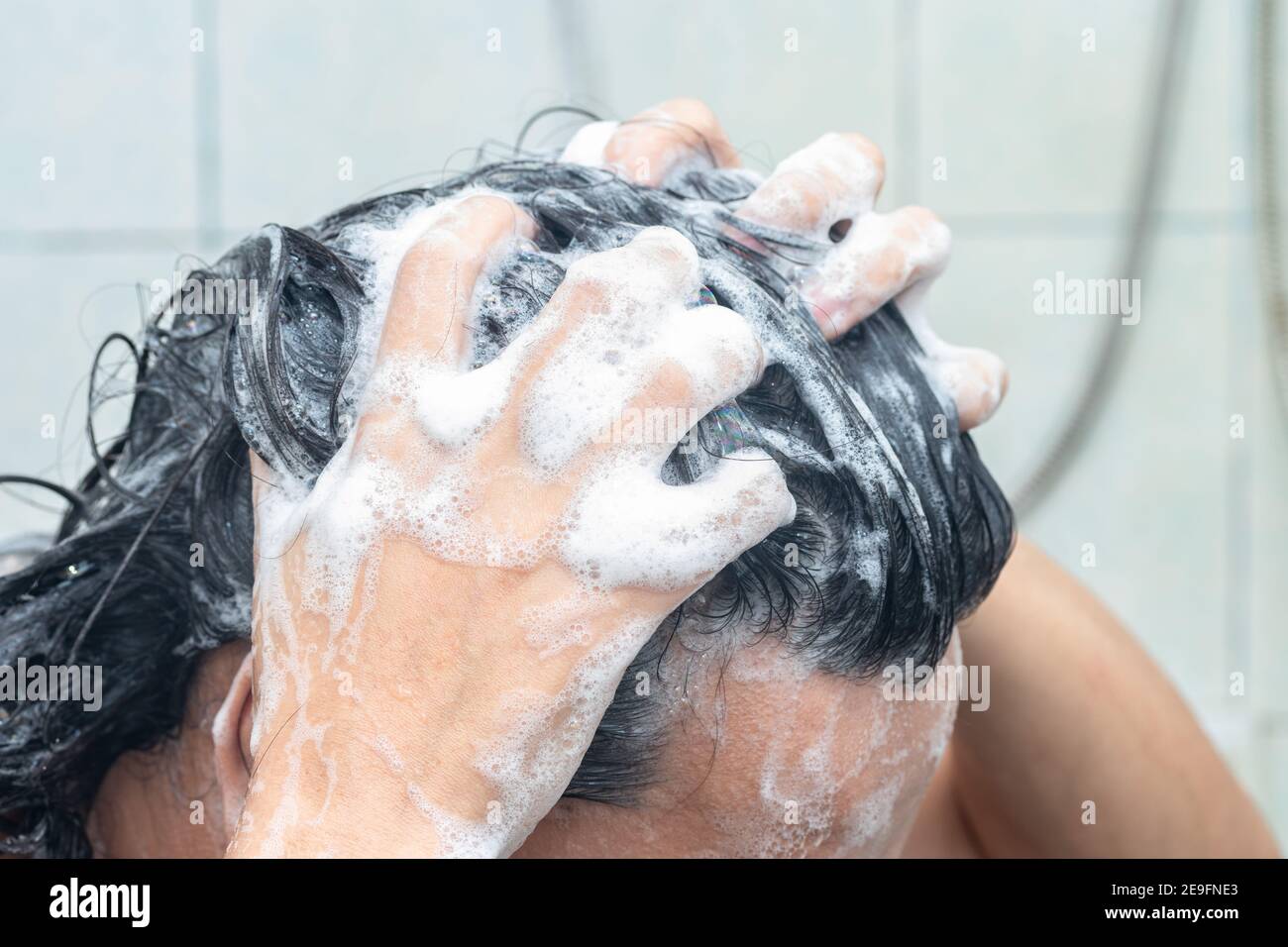 Woman washing hair in shower hi-res stock photography and images - Alamy