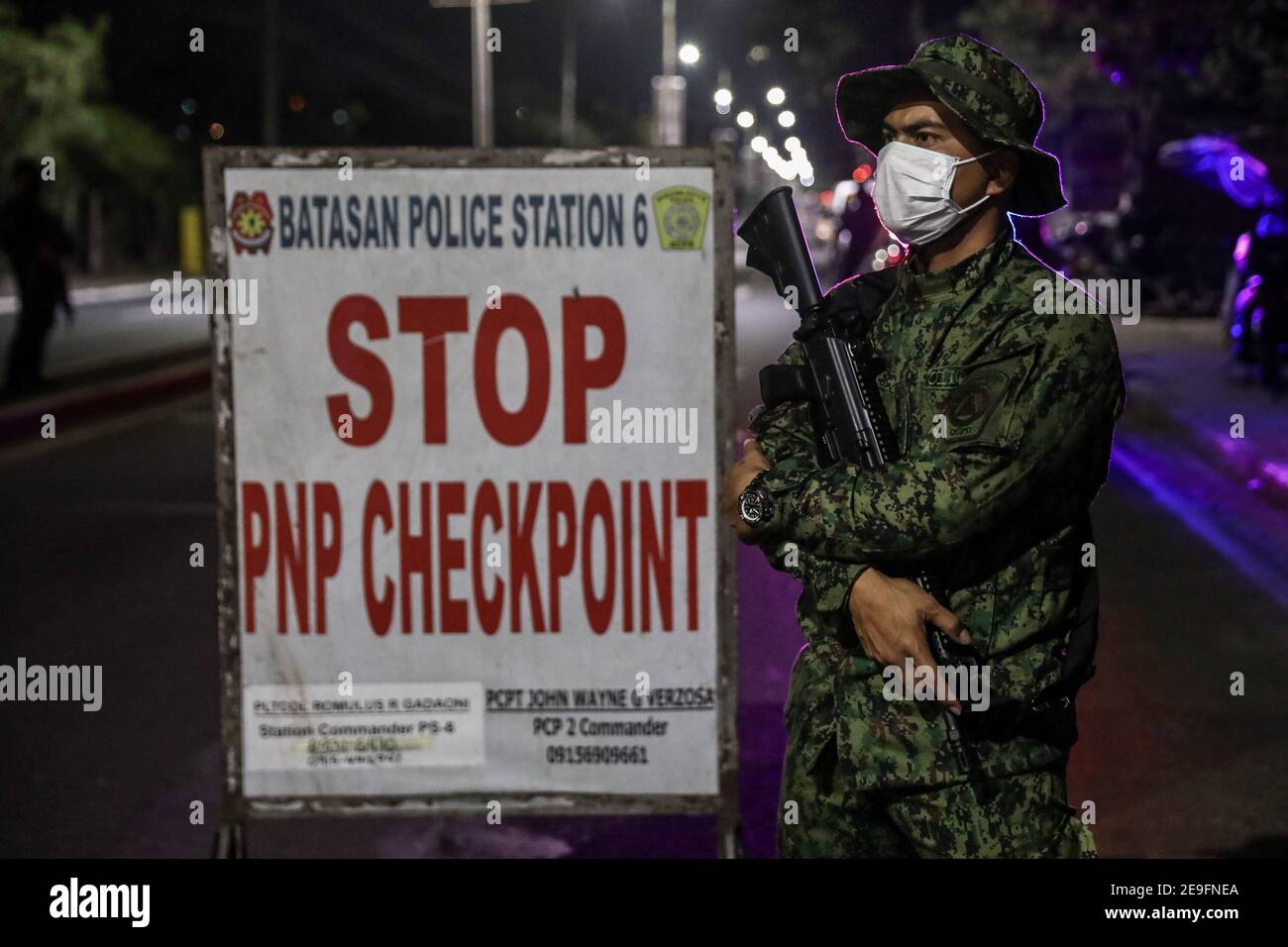 Filipino soldiers stand guard at a checkpoint after being deployed as ...