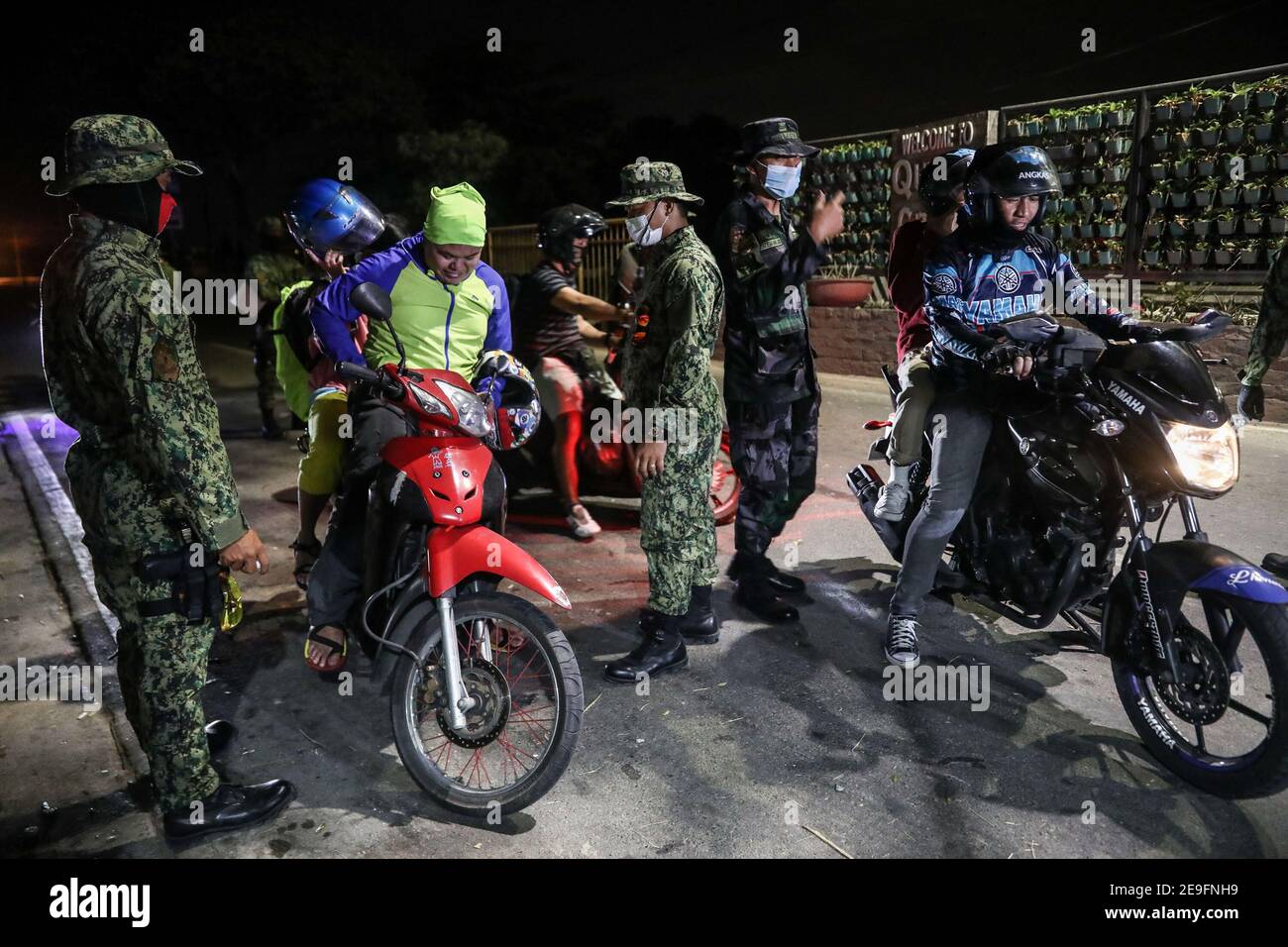 Filipino soldiers stand guard at a checkpoint after being deployed as ...