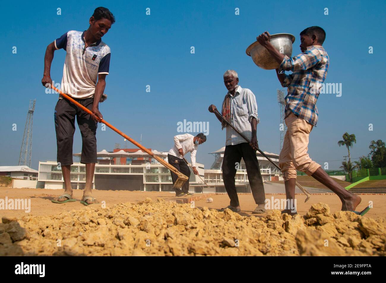 Workers preparing the ground with the complex and stands in the ...