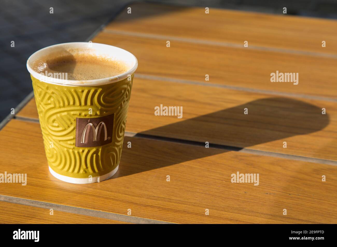 Great coffee in the original paper cup in McDonalds. It is located on a ...
