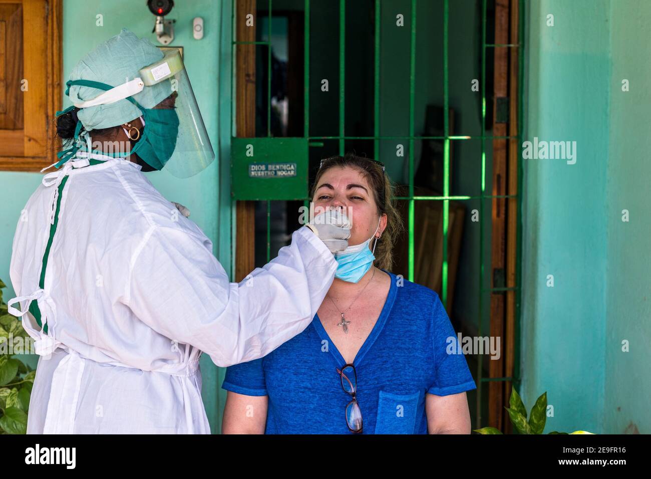 Cuban healthcare worker is testing foreign visitors at their home after ...