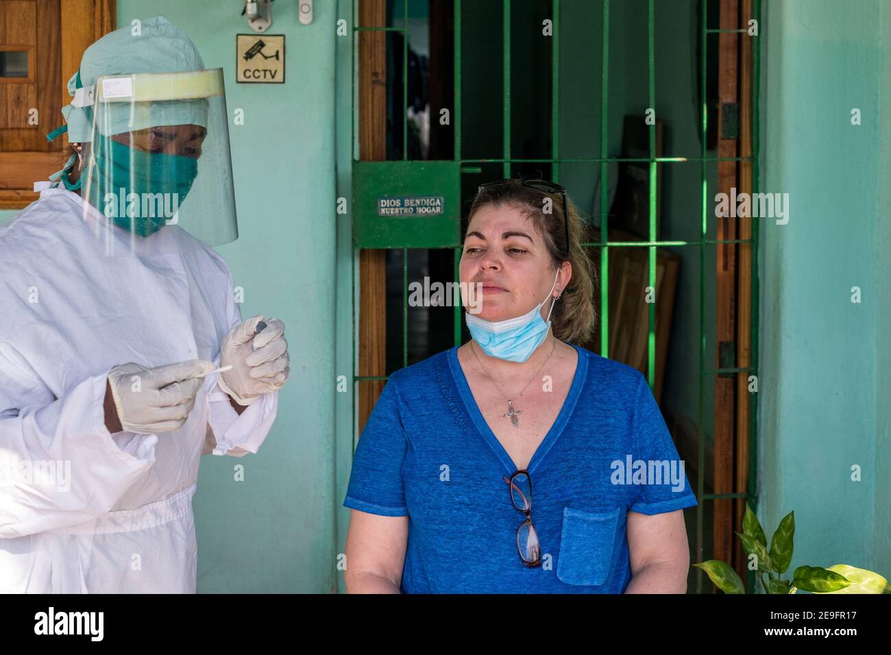Cuban healthcare worker is testing foreign visitors at their home after ...