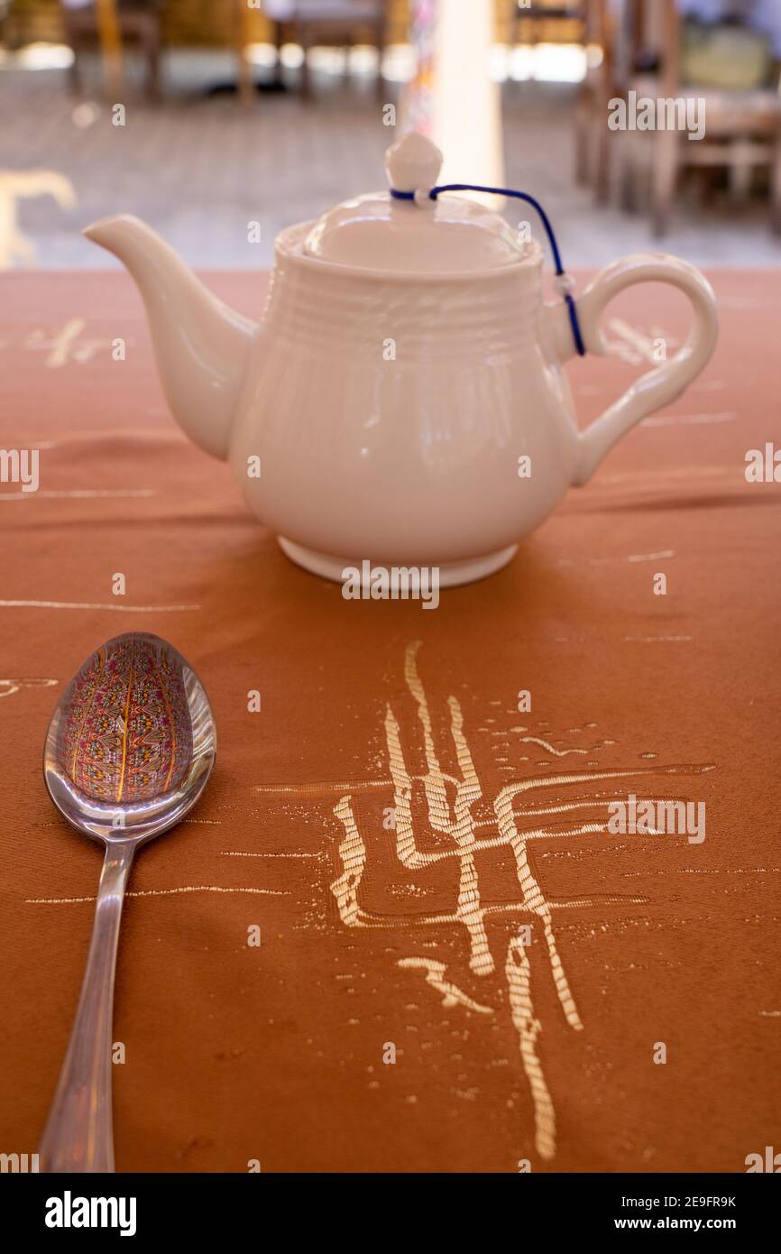Teapot and spoon reflecting patterned cover of a Khivan tapchan Stock ...