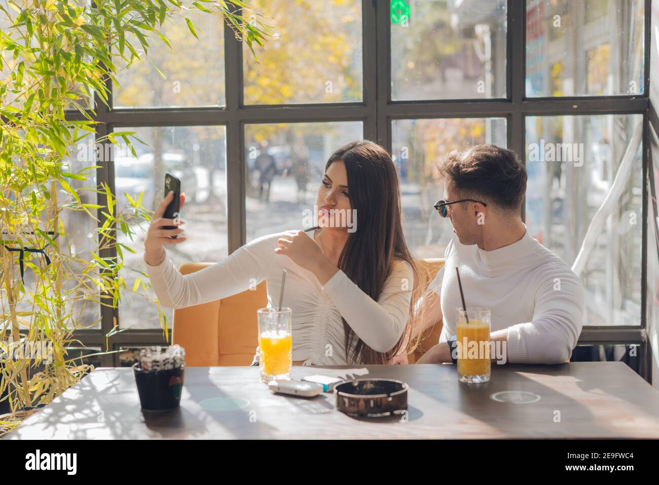 Friends socializing, having fun, and laughing drinking coffee in ...