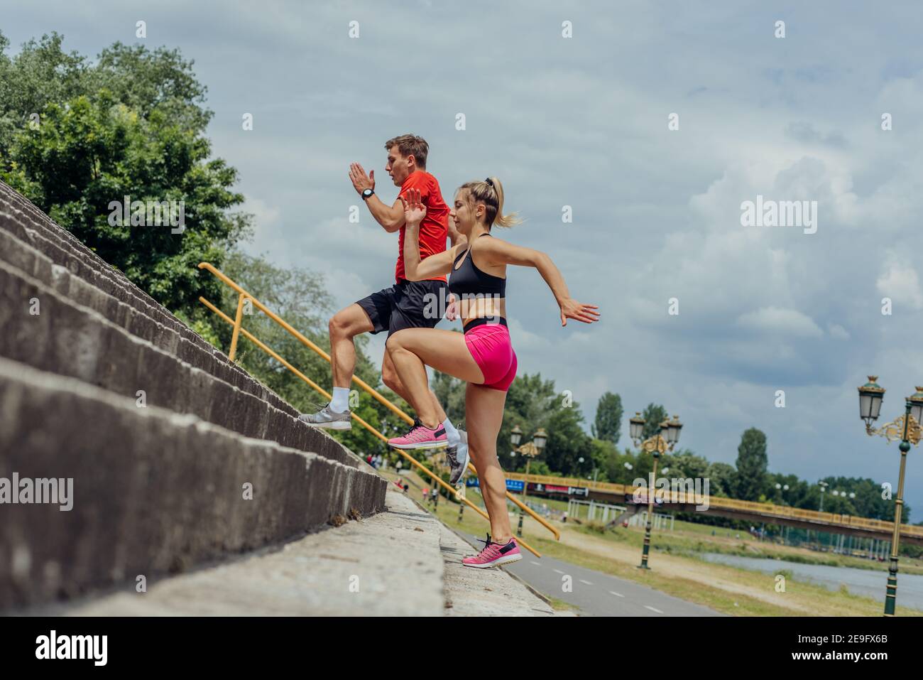 Healthy active couple exercising cardio and sprinting staircase in a ...