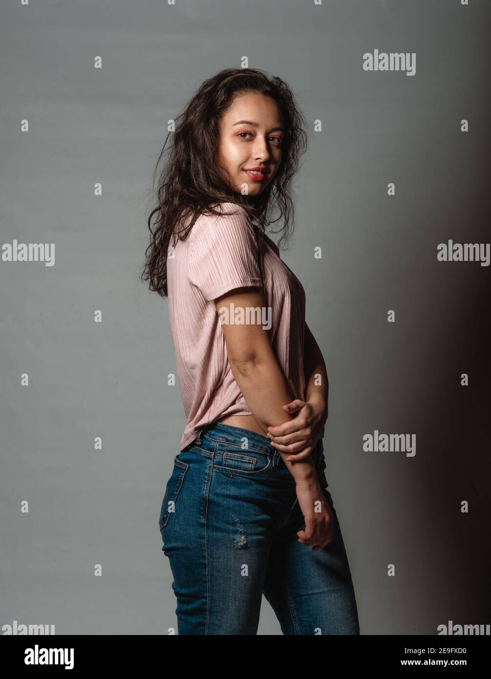 Portrait of an cheerful female model posing in modern style clothes ...