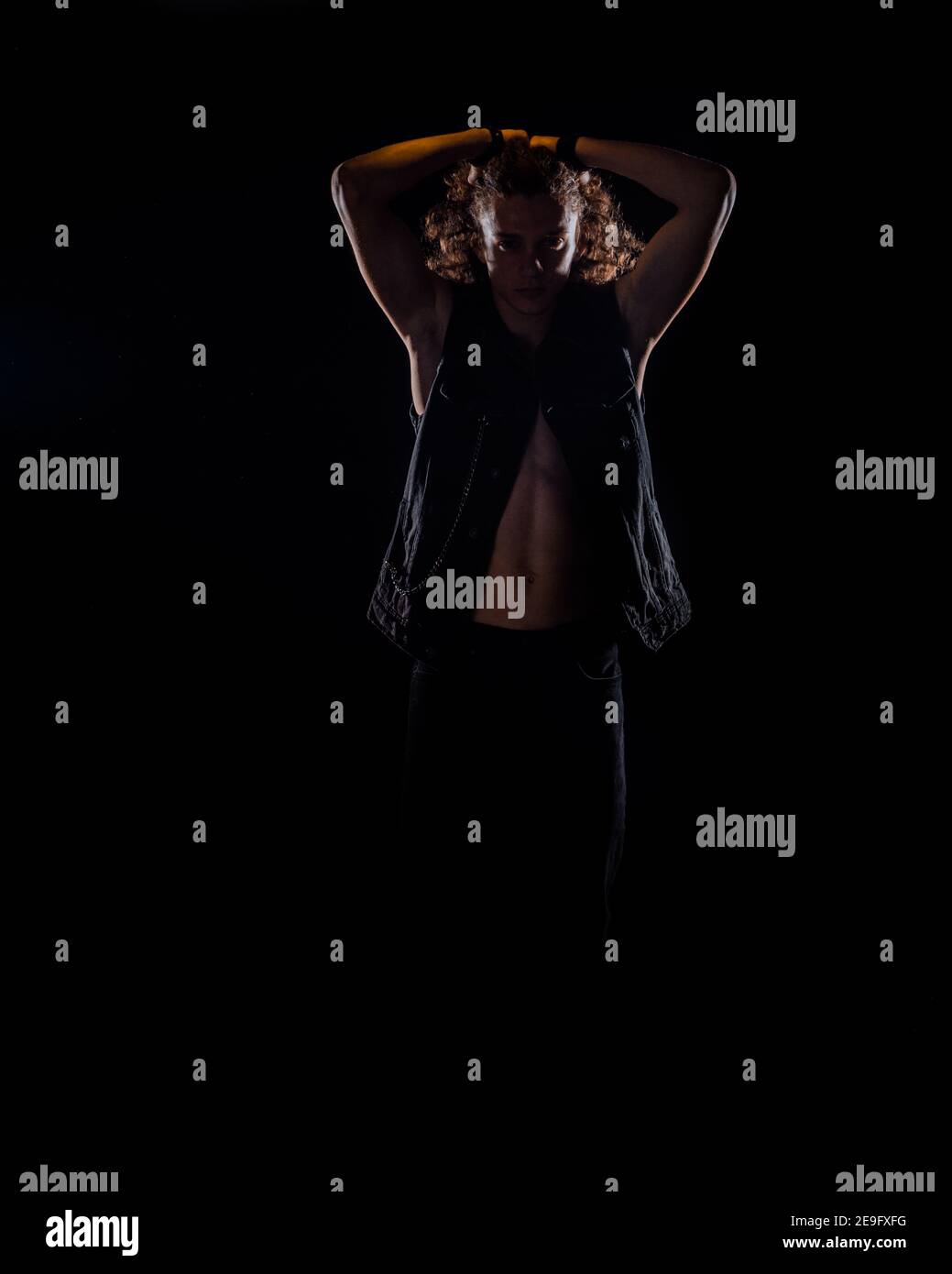 Cool punk boy dressed in black jeans vest, black jeans and sneakers ...