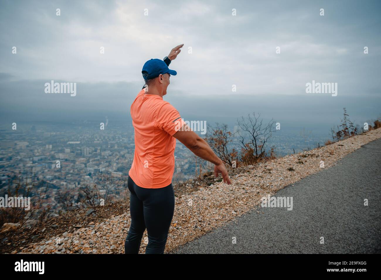 Older man in good shape warming up before running outdoors Stock Photo ...
