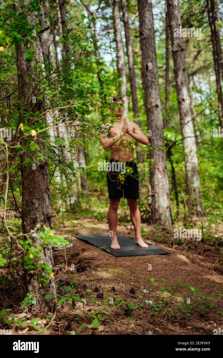 Image of a handsome cheerful young sports fitness man standing in green ...