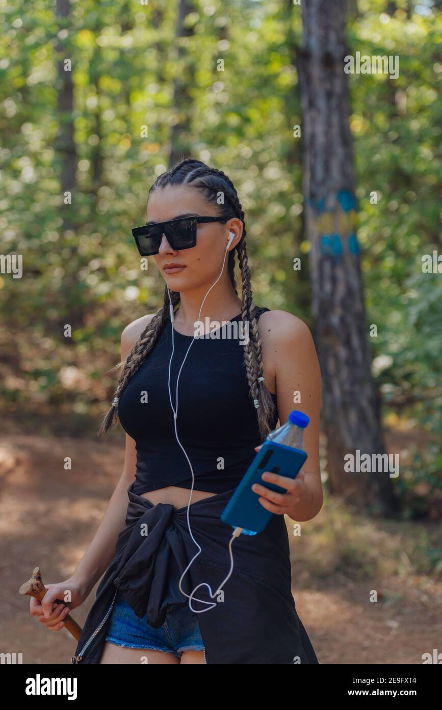 Sisters hiking through beautiful woods while wearing a backpack and ...