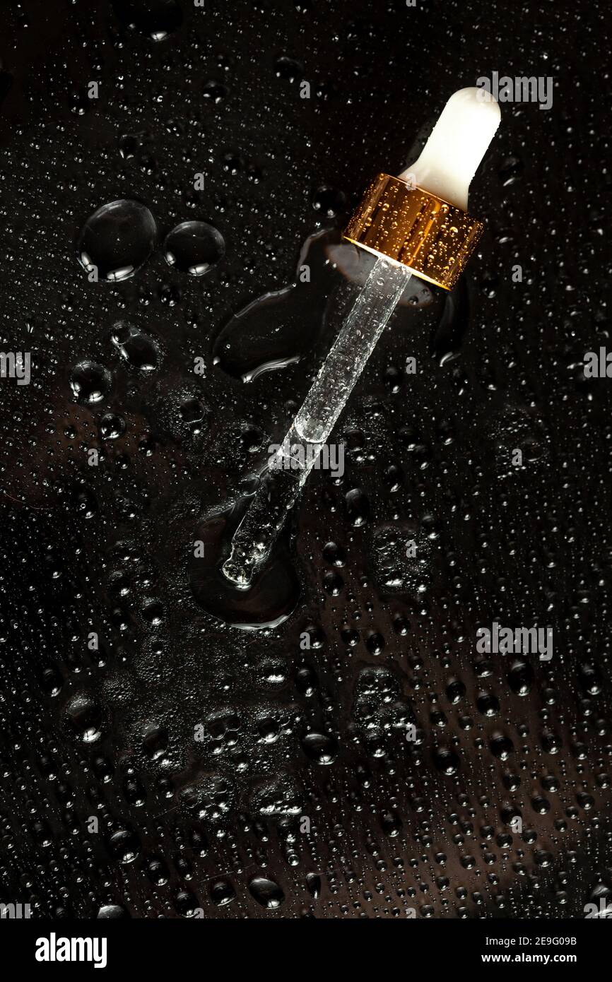 black glass background with medicine dropper and water splashes Stock ...
