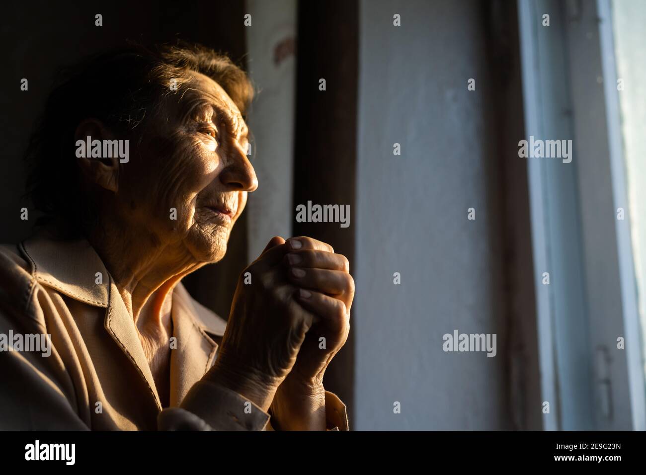 Close up portrait of an old woman praying Stock Photo - Alamy