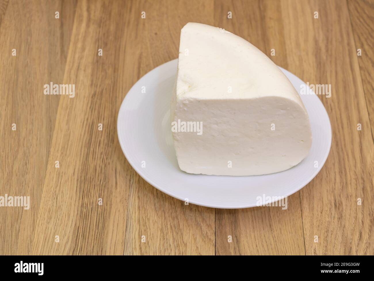 Fresh sheep cheese in a plate on wooden background Stock Photo - Alamy