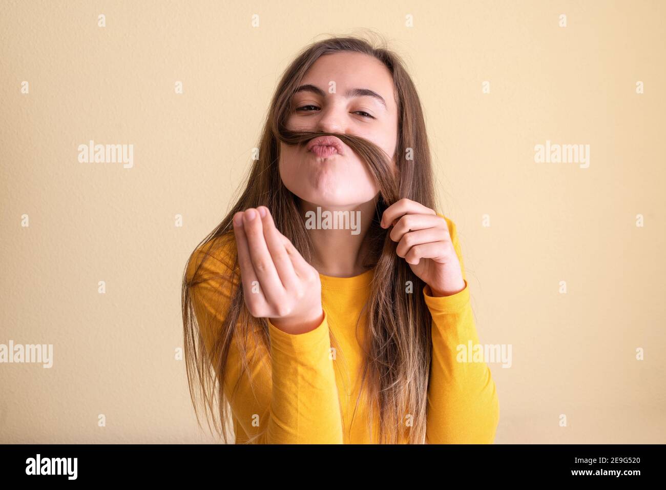 Young girl having fun playing with her hair Stock Photo - Alamy