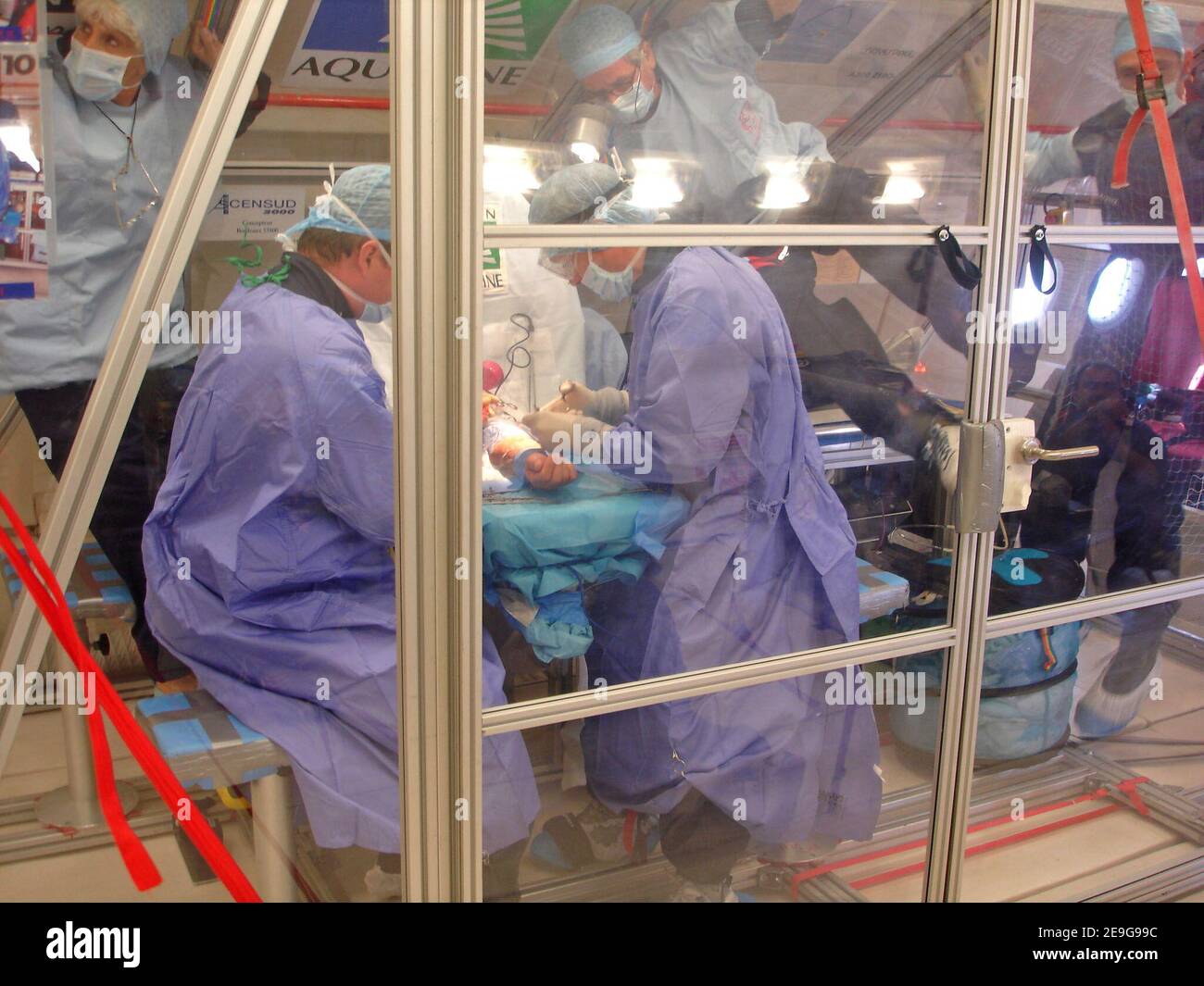 Surgeons performing robotic operation hi-res stock photography and ...