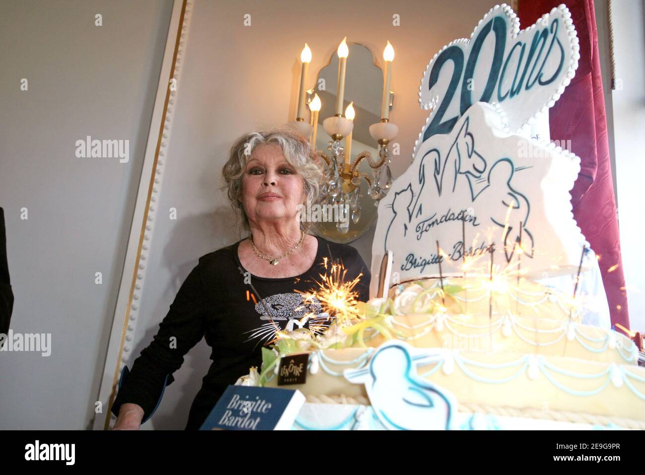 French legend Brigitte Bardot poses in front of the giant cake during ...