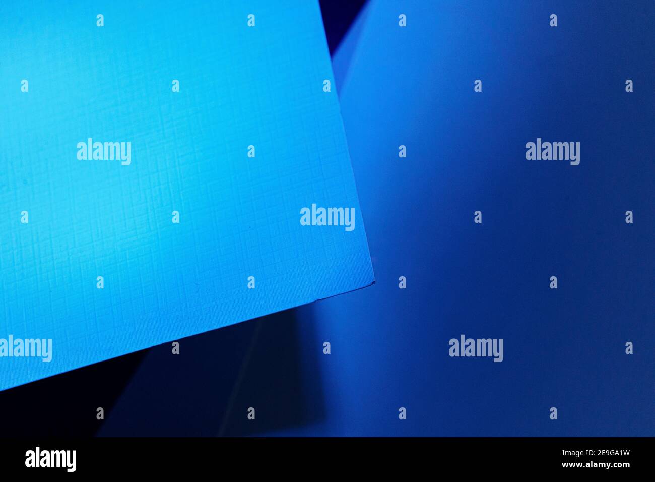 Blank carton paper sheets background in dark blue light Stock Photo - Alamy