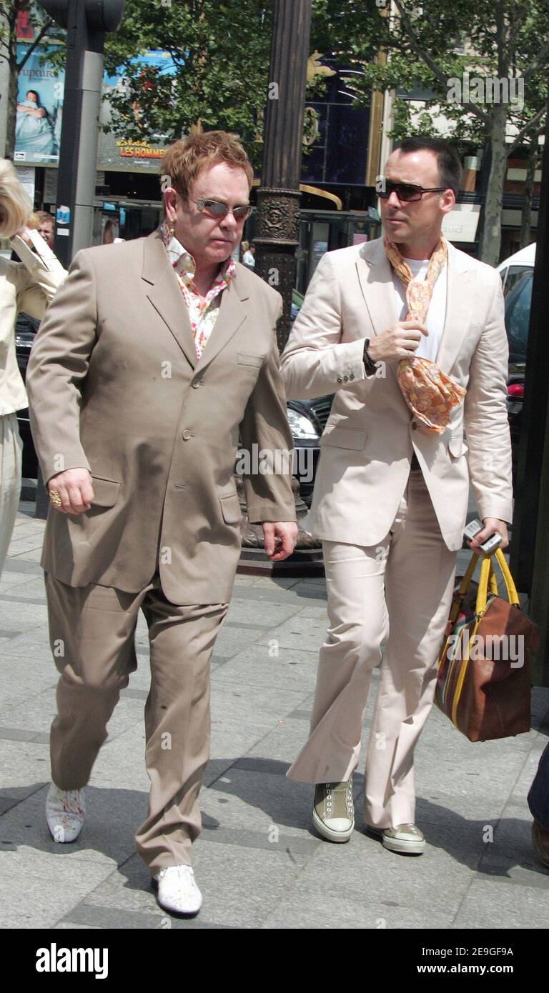 Elton John and his partner David Furnish take a walk on the Champs ...