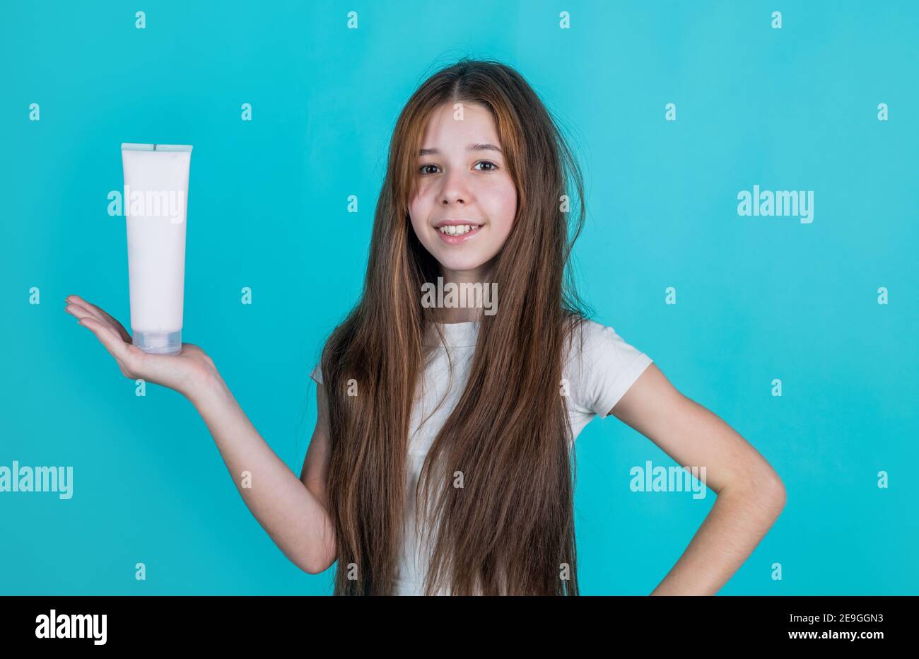 wash and rinse. happy teen girl presenting cosmetic product. shampooing ...