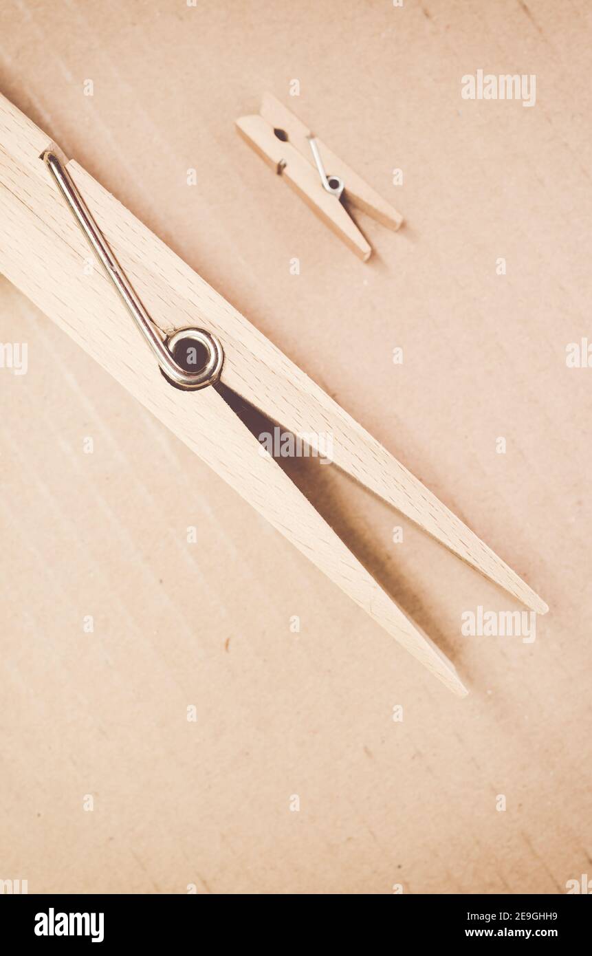 Vertical top view of big and small wooden clothespins Stock Photo - Alamy