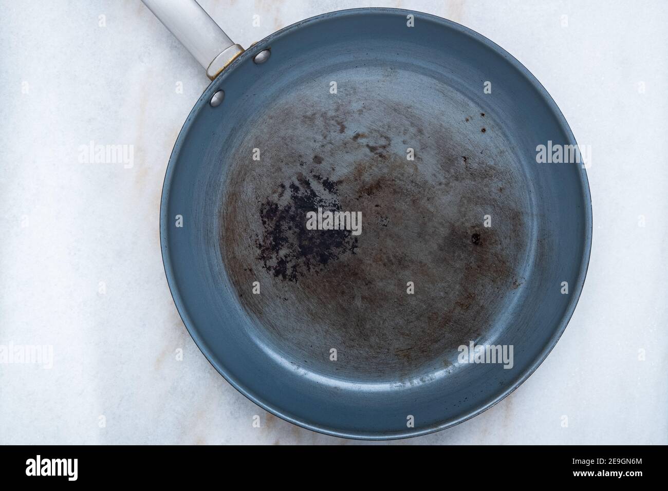 A ruined, non stick skillet on the kitchen counter Stock Photo - Alamy