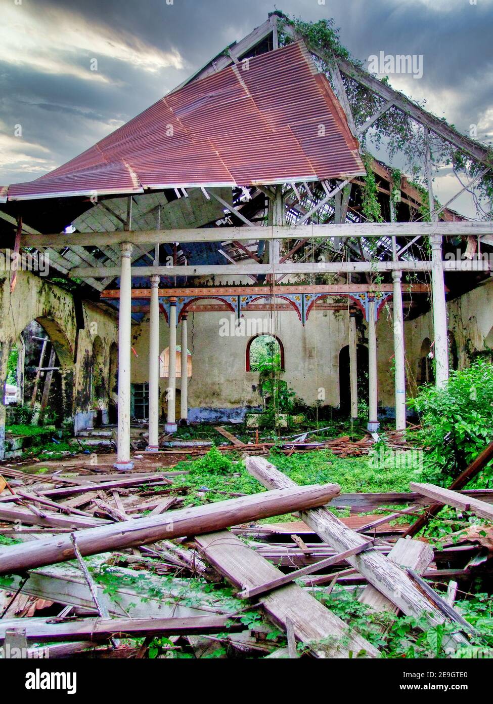 Vertical shot of an old ravaged building with overgrowth Stock Photo ...