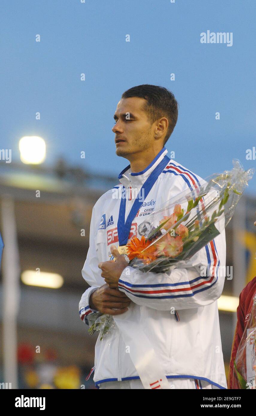 France's Mehdi Baala celebrates on the podium as he wins the gold in ...